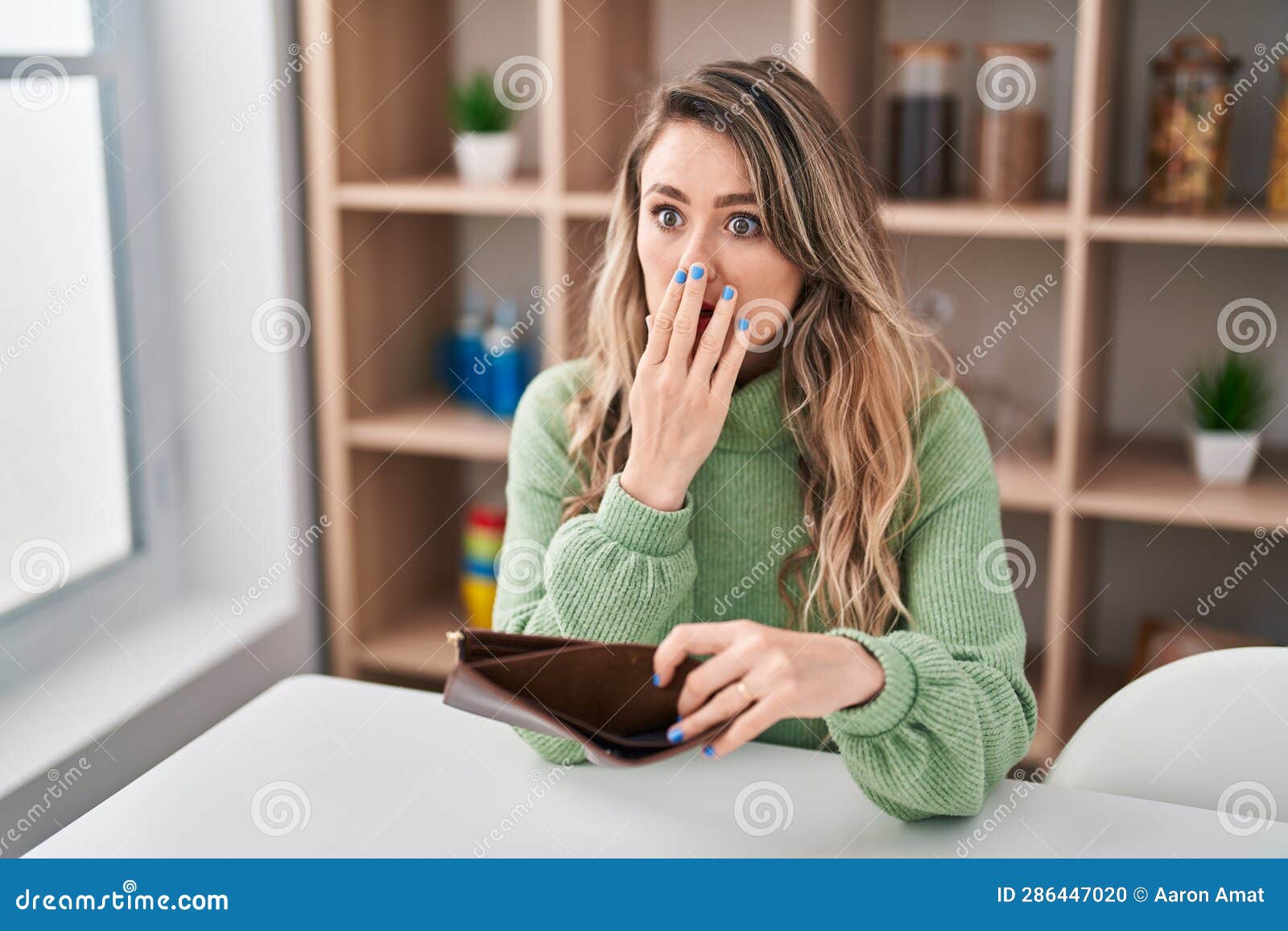 Young Woman Opening Empty Wallet at Home Stock Photo - Image of table ...