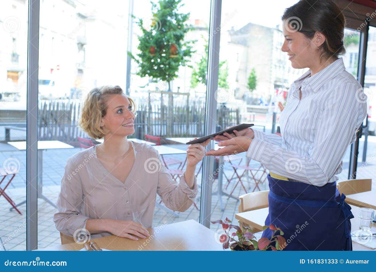 Young Woman Ordering Food from Waitress Stock Image - Image of customer ...