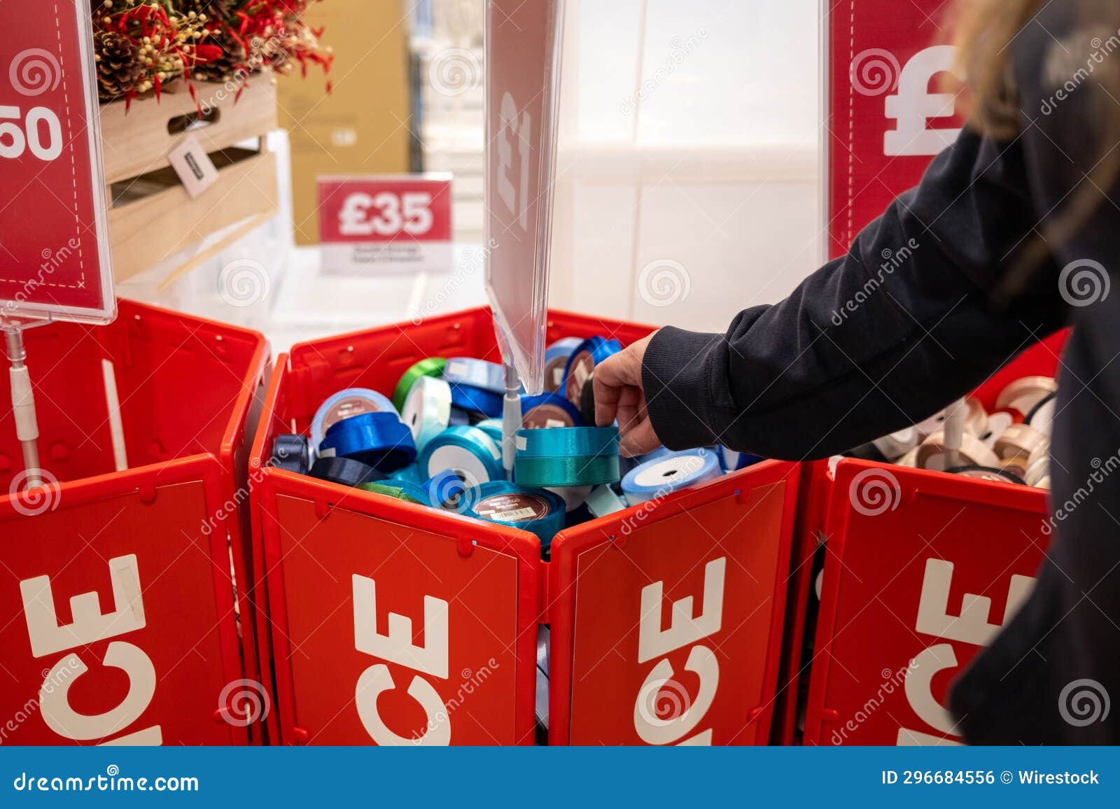 A Woman Putting Things in the Bins at a Store Stock Photo - Image of ...
