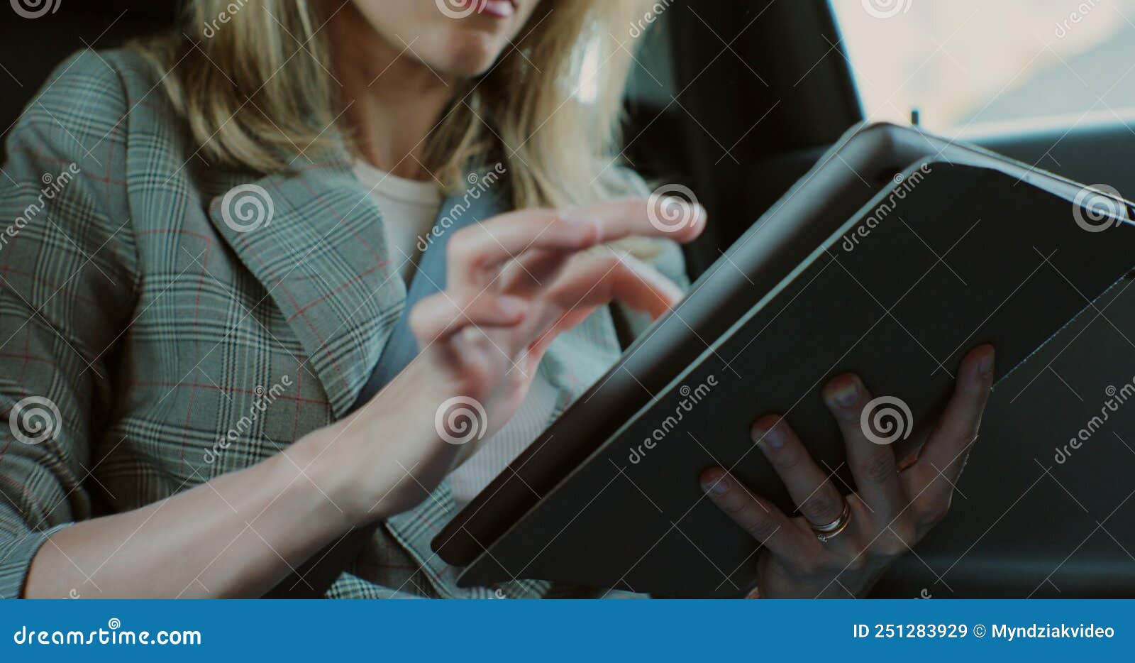 Young Woman Passenger Using a Digital Tablet, Sits in the Back Seat of ...