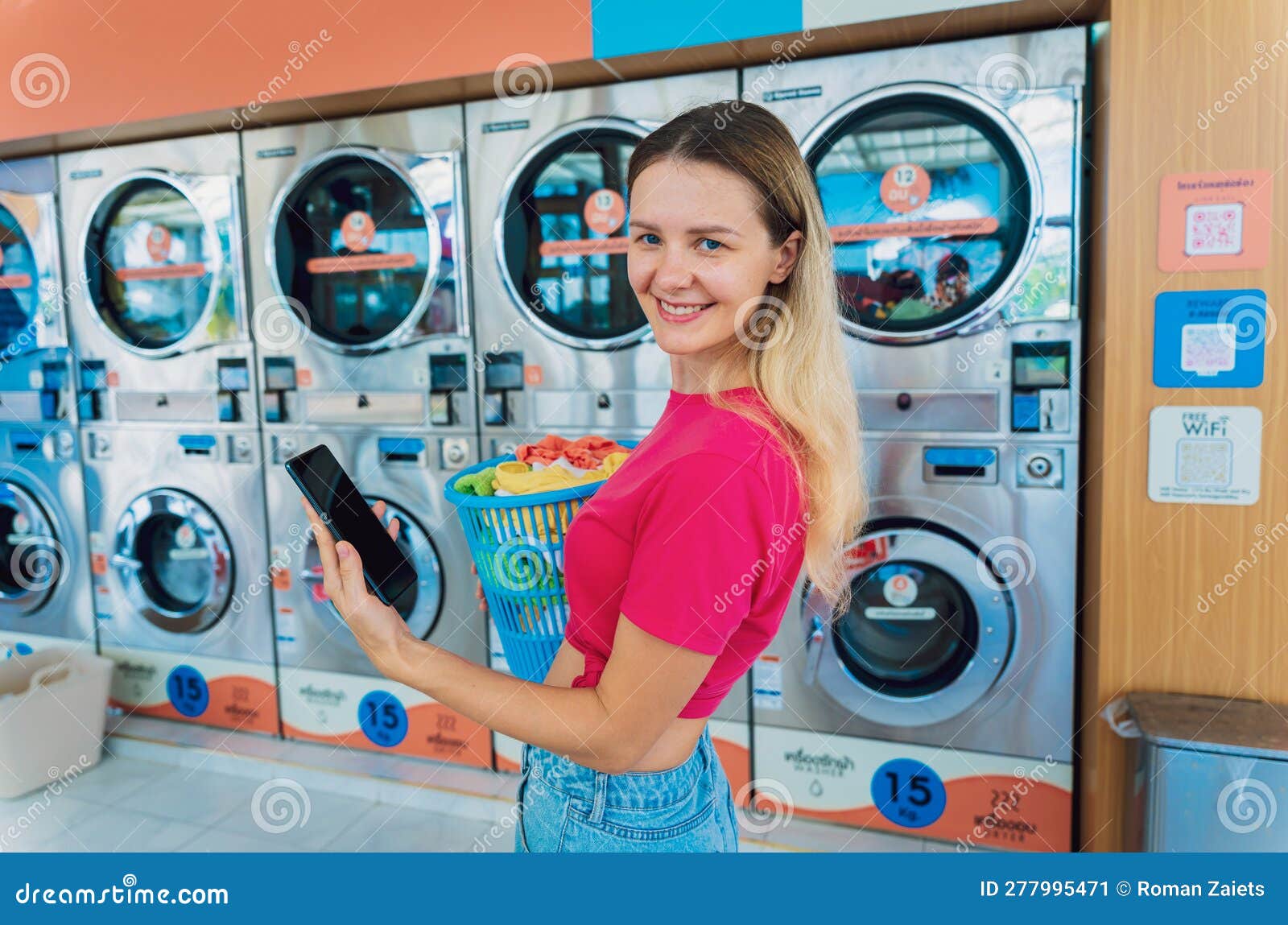 Young Woman Pays for Laundry Service Using Phone and Banking ...