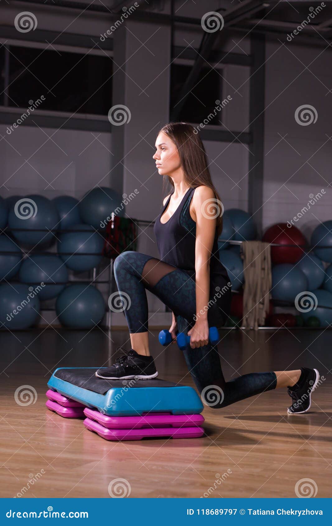 Young Woman Performs Step Cardio with Dumbbells in a Gym Stock Image ...