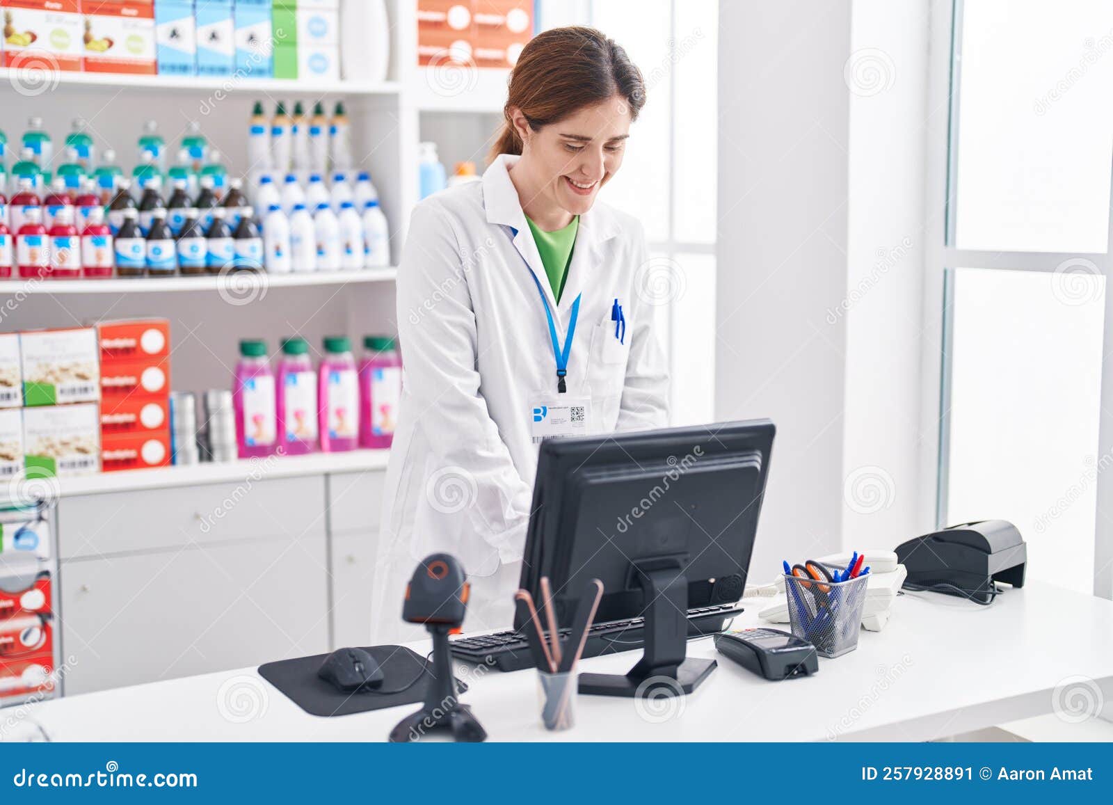 Young Woman Pharmacist Smiling Confident Using Computer at Pharmacy ...
