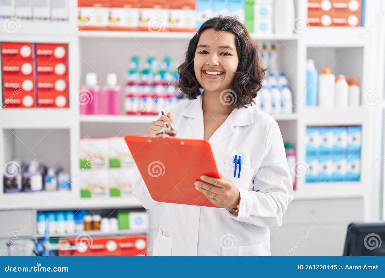 Young Woman Pharmacist Writing on Document at Pharmacy Stock Image ...