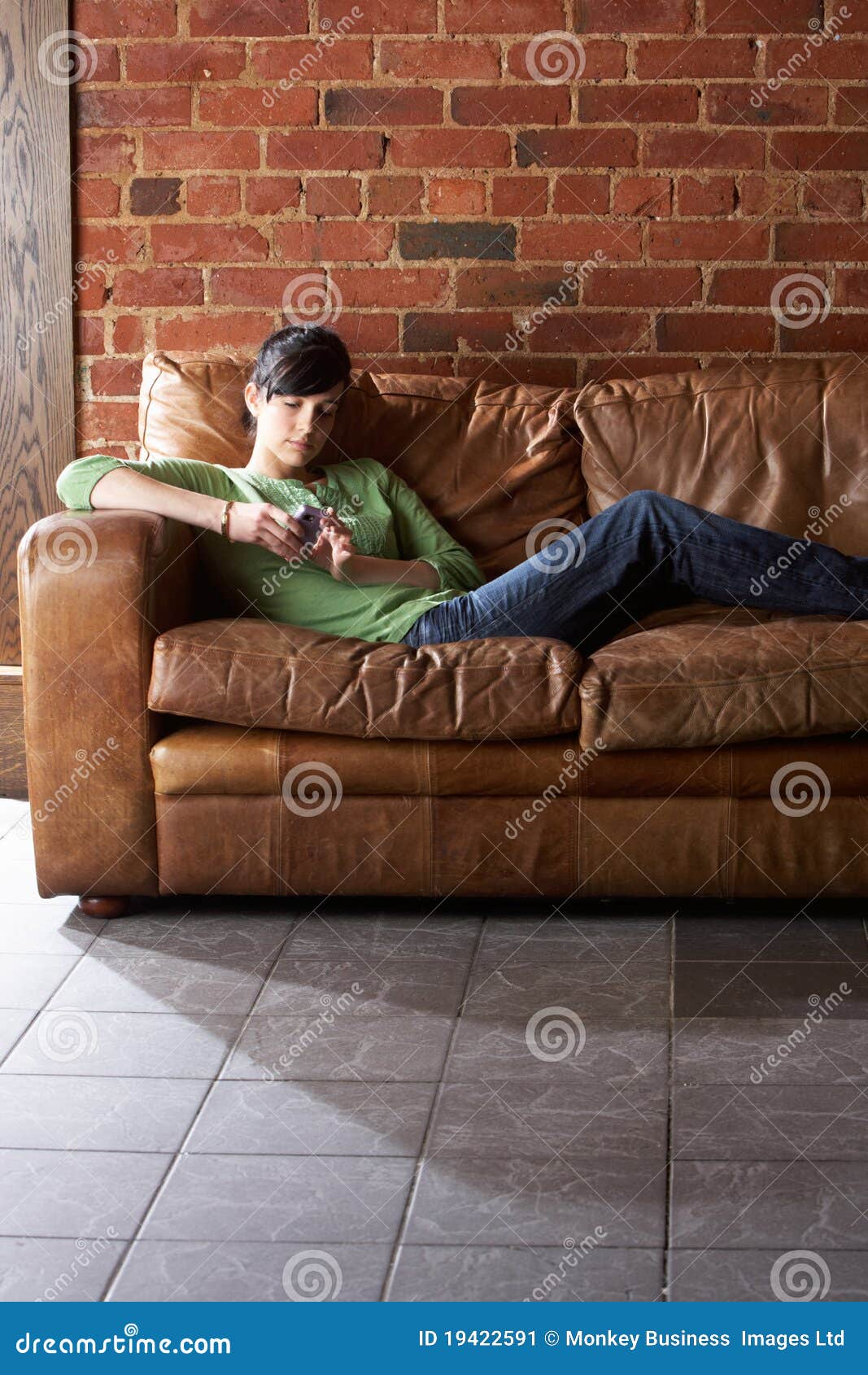 Young Woman with Phone on Sofa Stock Image - Image of lonely, checking ...