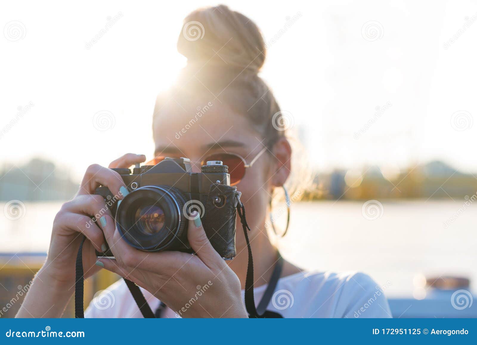 Young Woman Photographer Using a Camera in Bright Daylight Stock Image ...