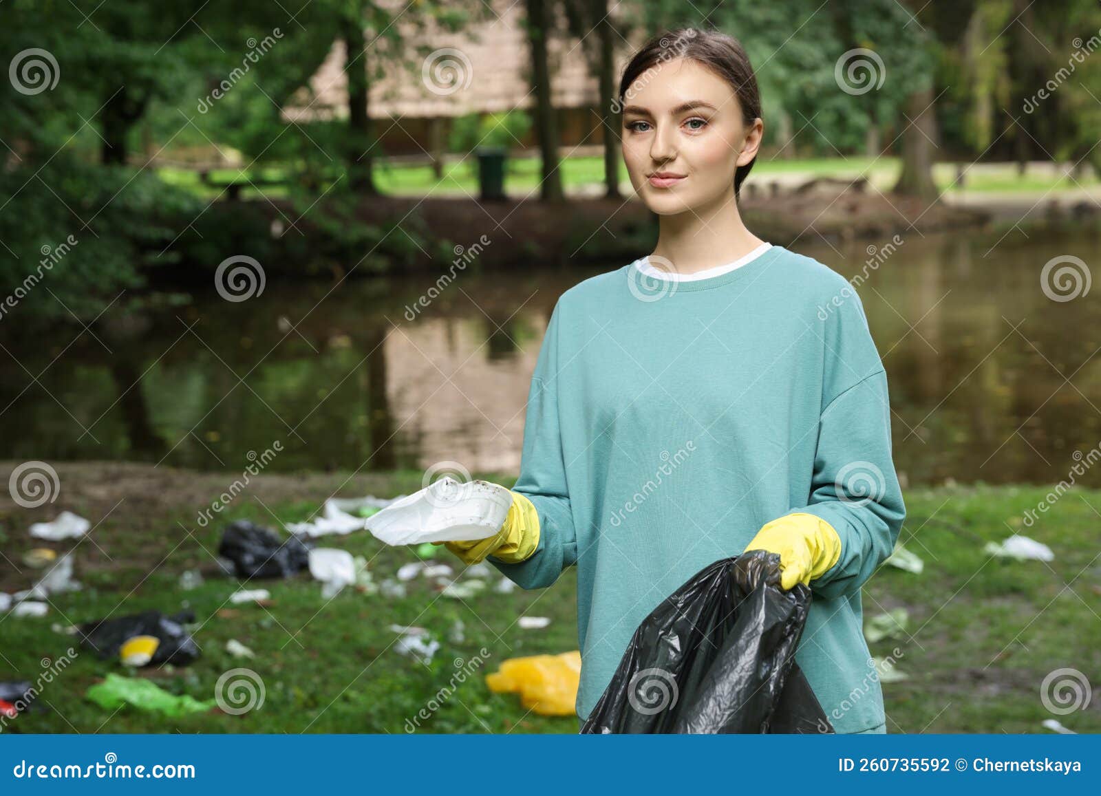 Young Woman with Plastic Bag Collecting Garbage in Park Stock Photo ...