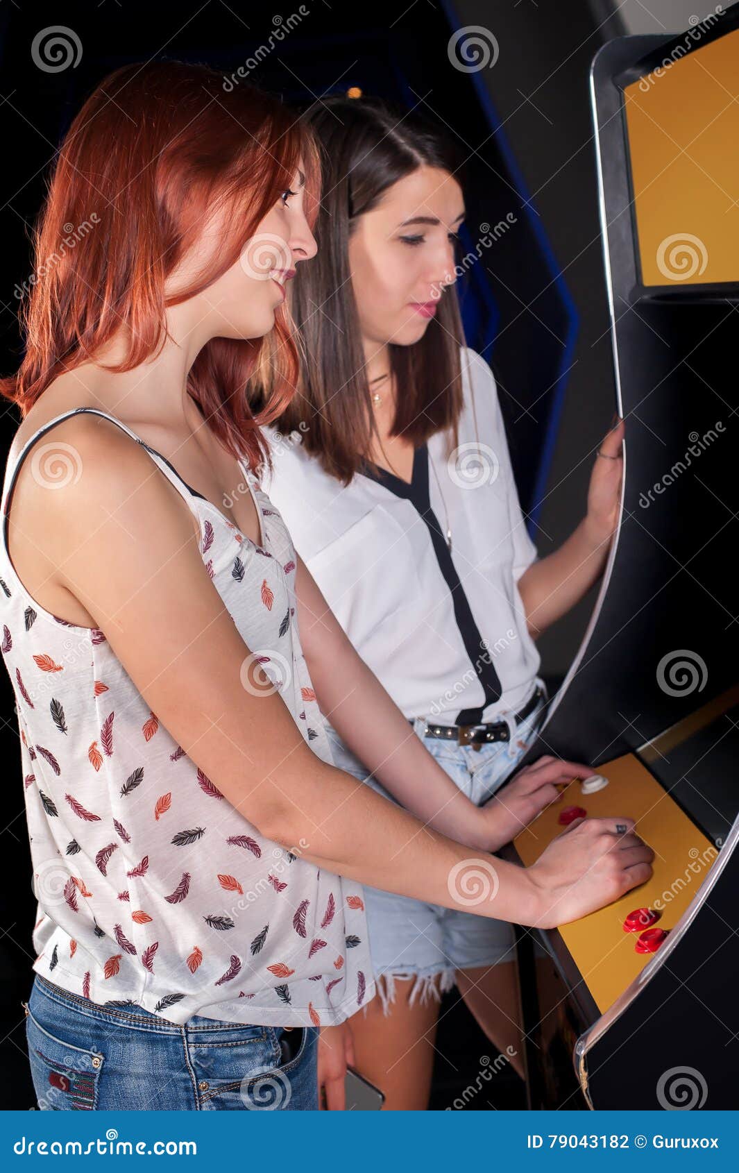 Young woman playing arcade stock photo. Image of insert - 79043182