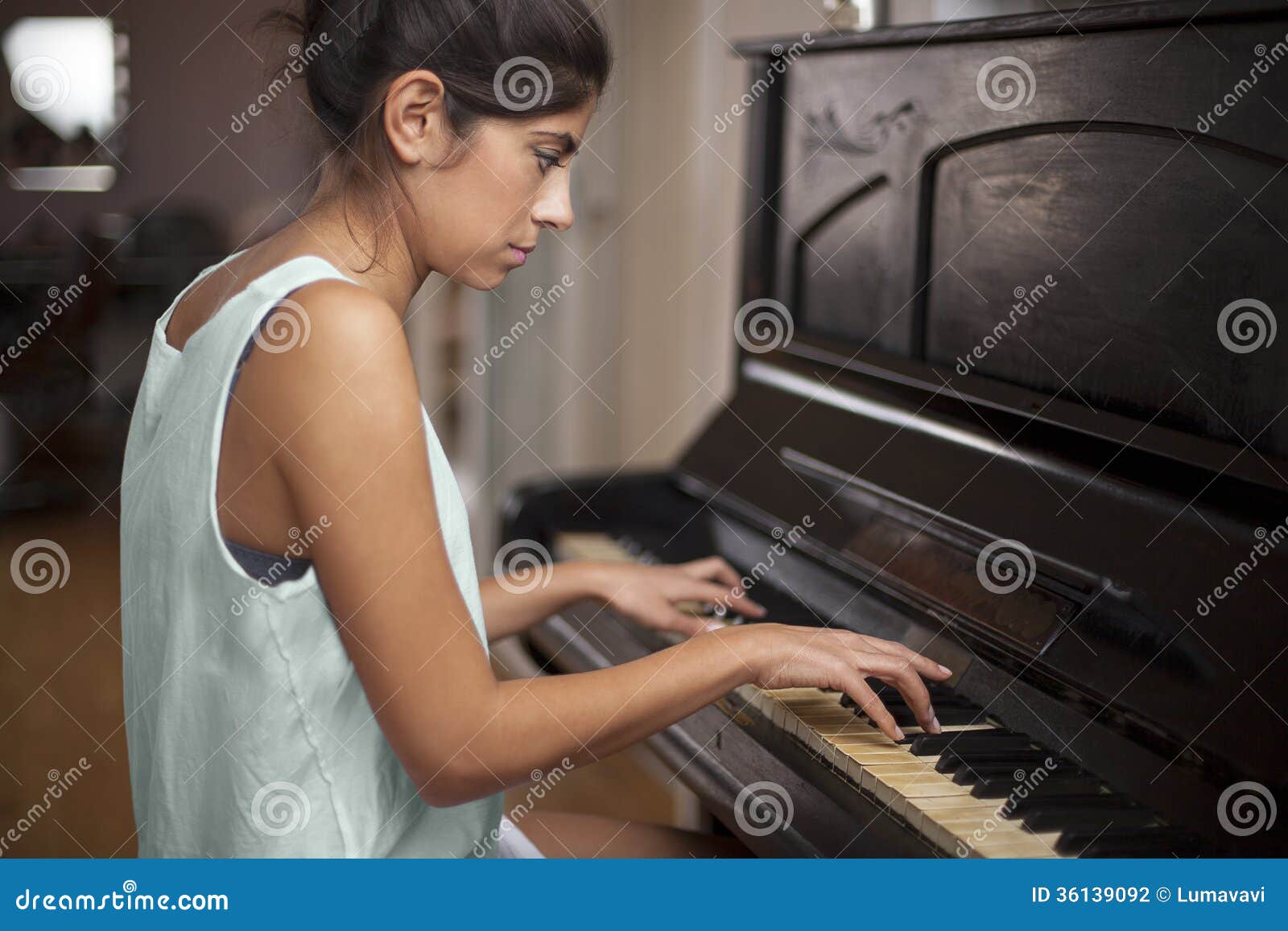 Young woman playing piano stock photo. Image of music - 36139092
