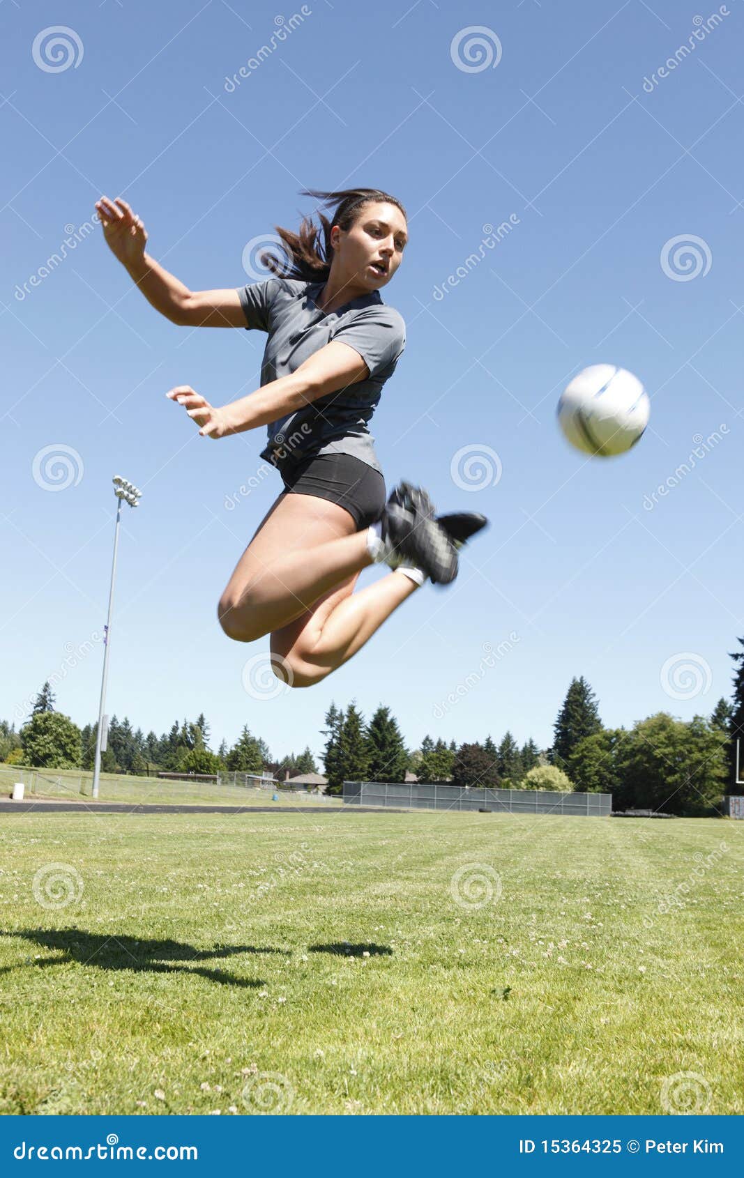 Young woman playing soccer stock image. Image of ball - 15364325
