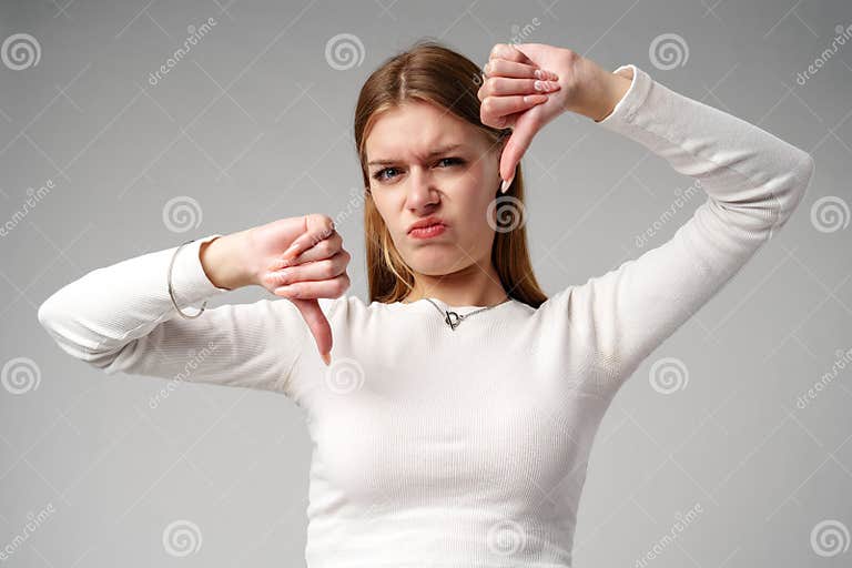 Young Woman Pointing Finger Down at Camera in Studio Stock Photo ...