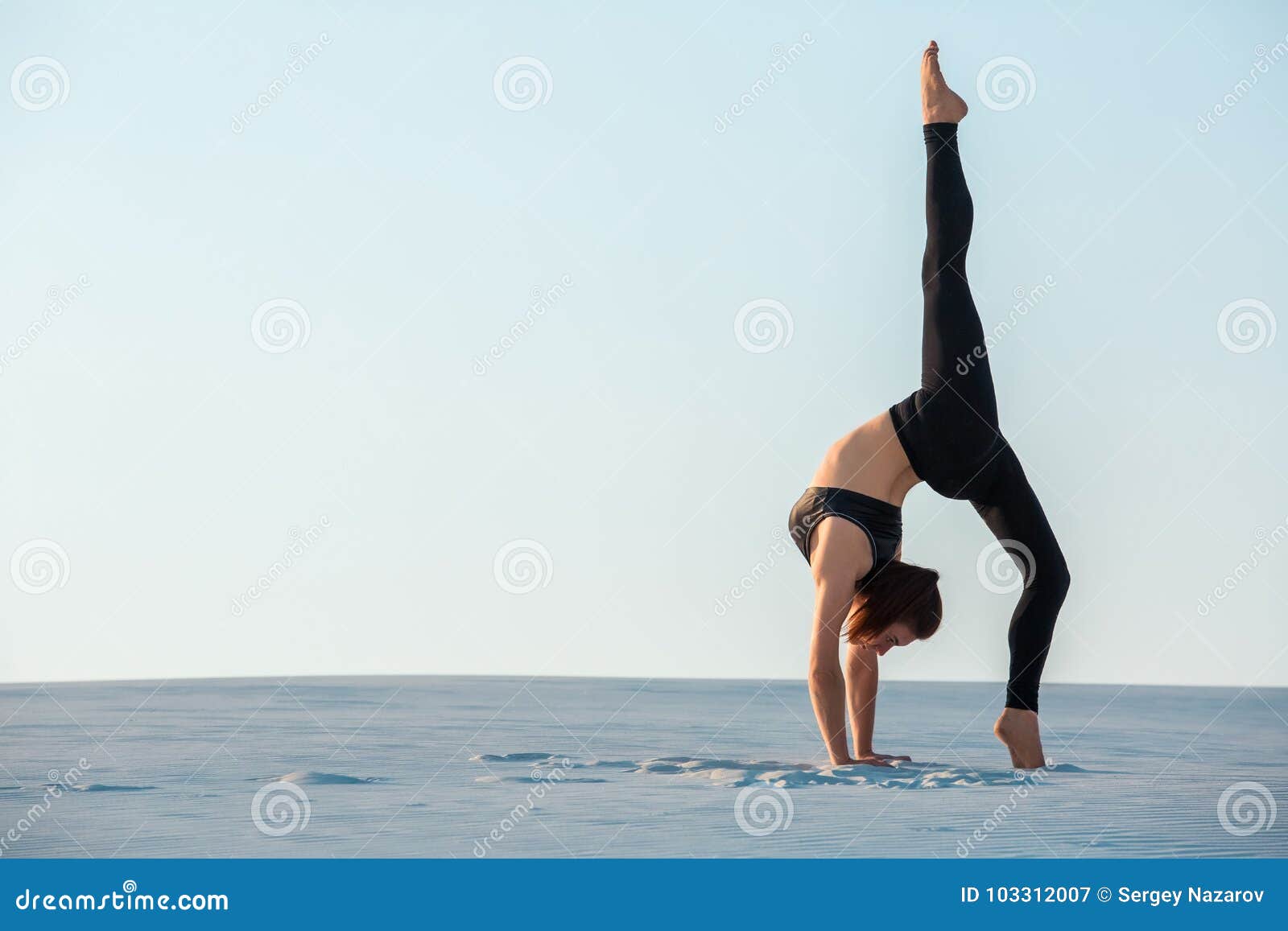 Young Woman Practicing Inversion Balancing Yoga Pose Handstand on Sand ...