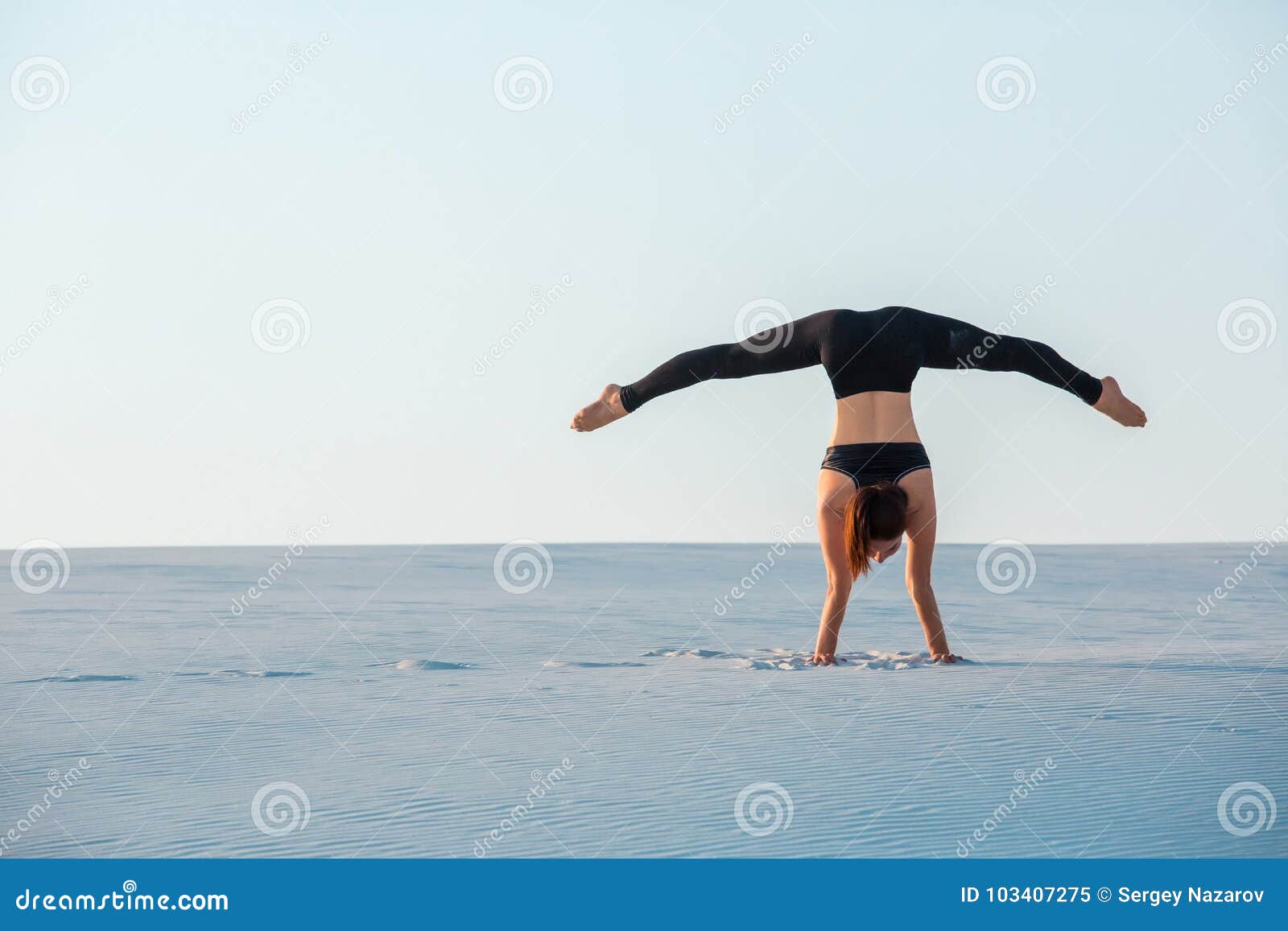 Young Woman Practicing Inversion Balancing Yoga Pose Handstand on Sand ...