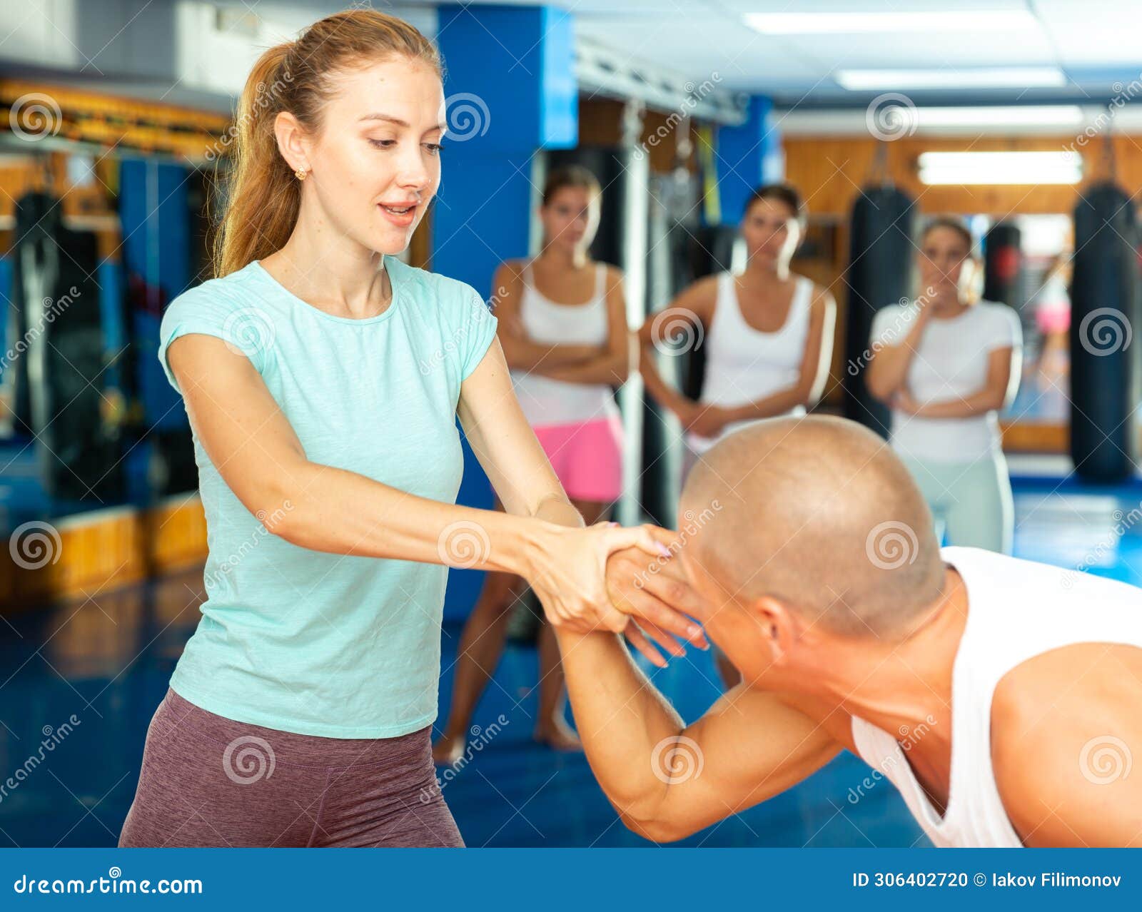 Young Woman Practicing Supinating Wristlock with Man in Self-defense ...