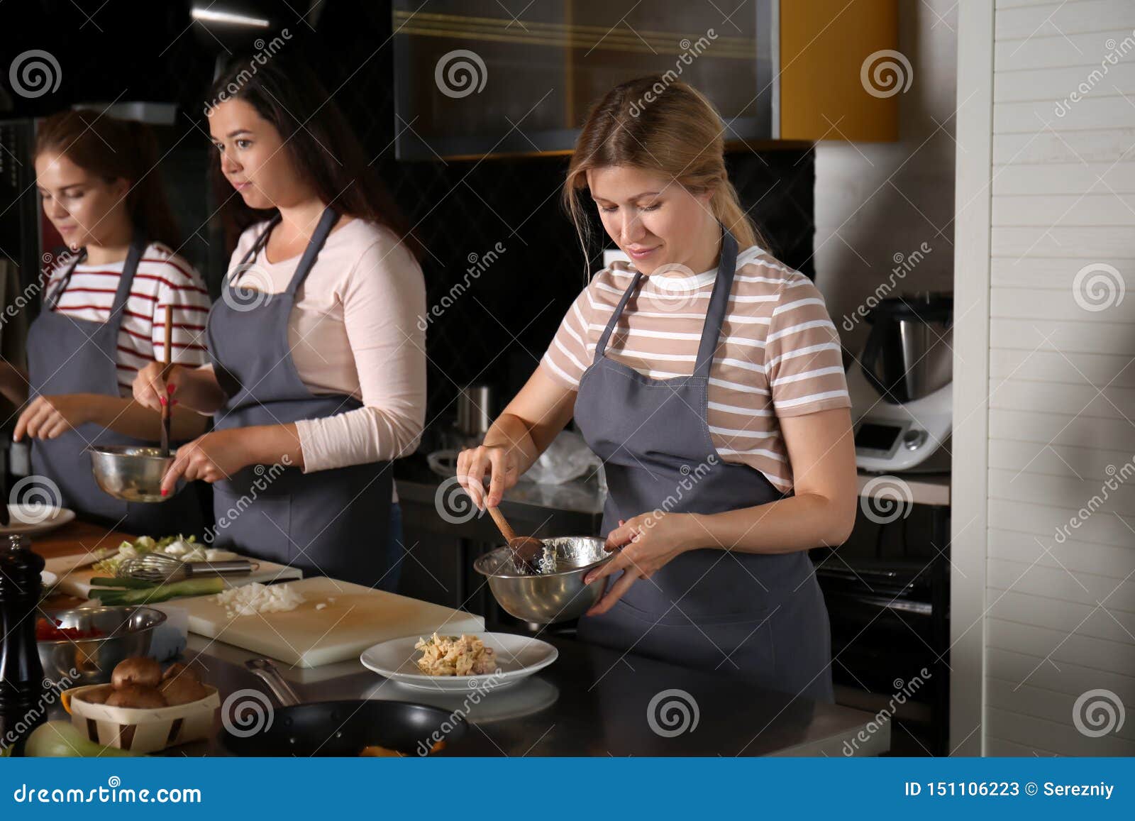Young Woman Preparing Meal During Cooking Classes On Restaurant Kitchen