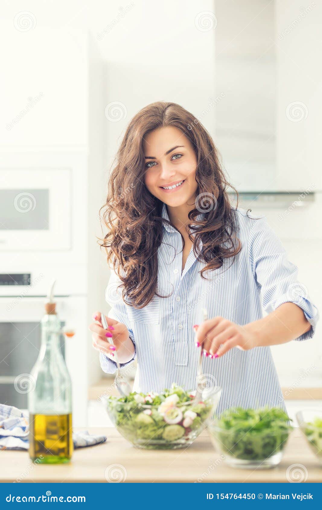 Young Woman Preparing Vegetable Salad In Her Kitchen Healthy Lifestyle
