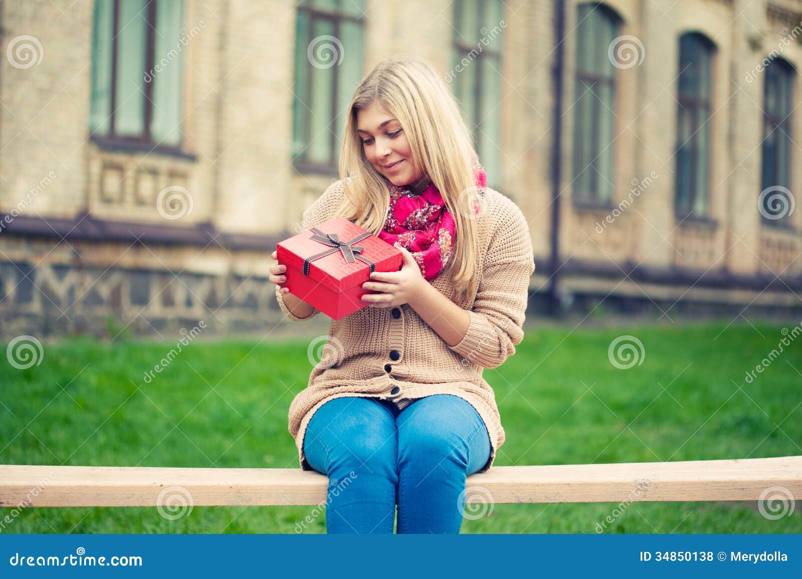 Young woman with present stock photo. Image of blond - 34850138