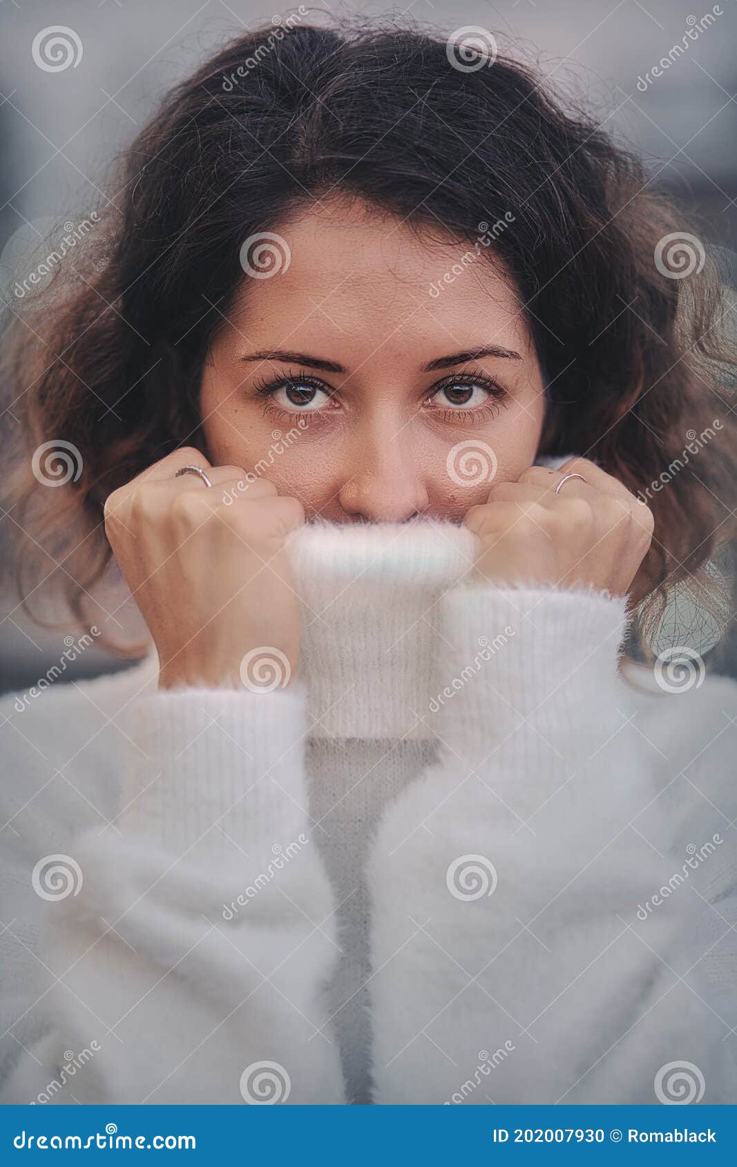 Young Woman Pulling Her White Sweater Over Head Stock Photo - Image of ...