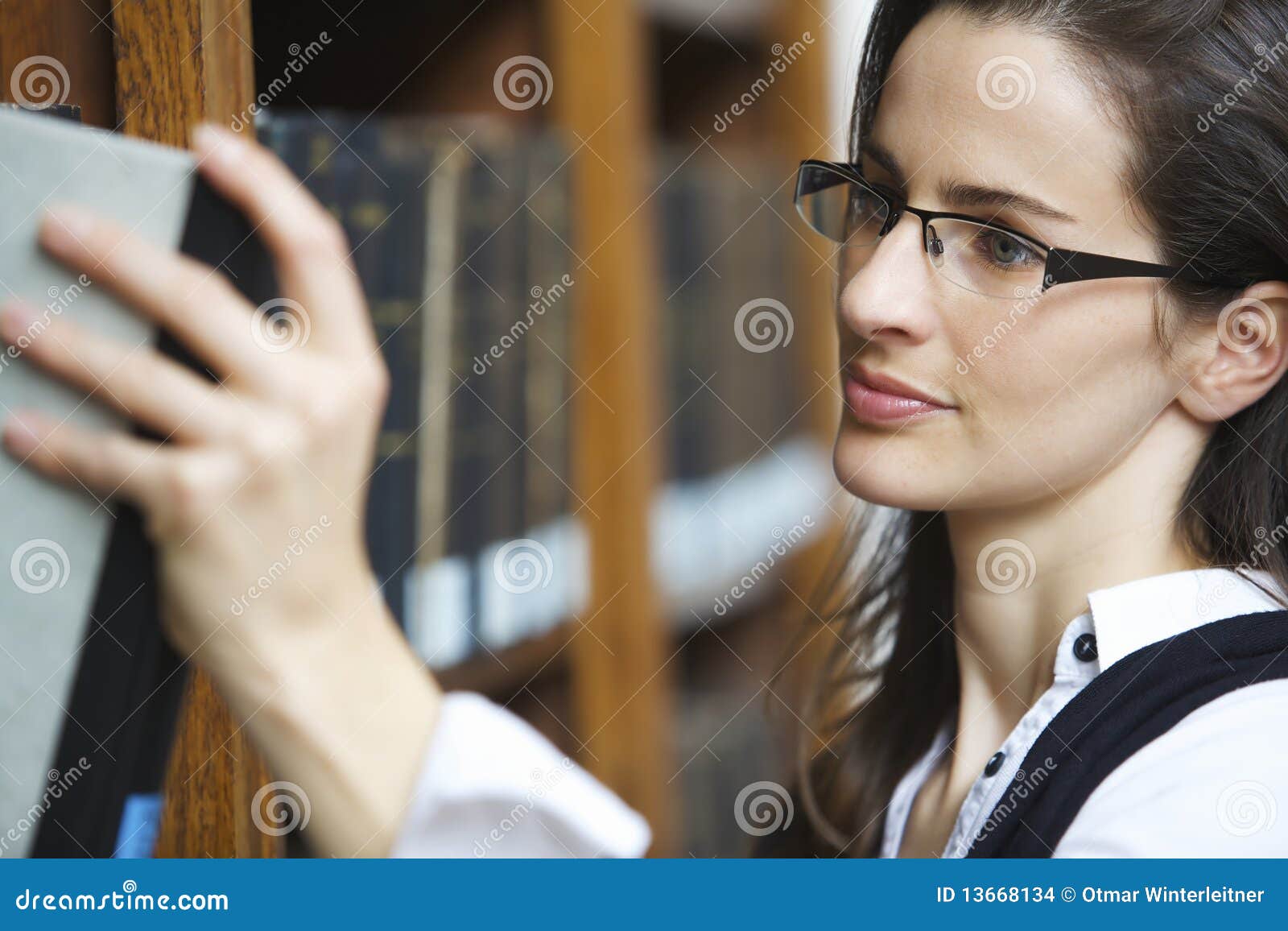 Young Woman Pulling Out Book Stock Photo - Image of beauty, happy: 13668134