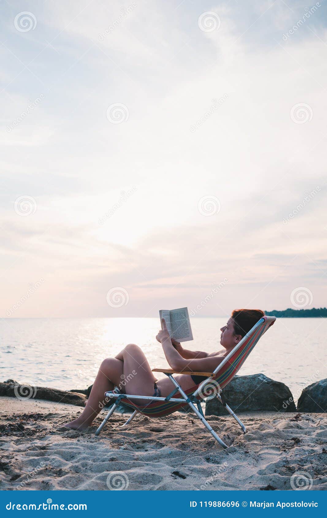 Young Woman Reading a Book on the Beach Stock Photo - Image of alone ...