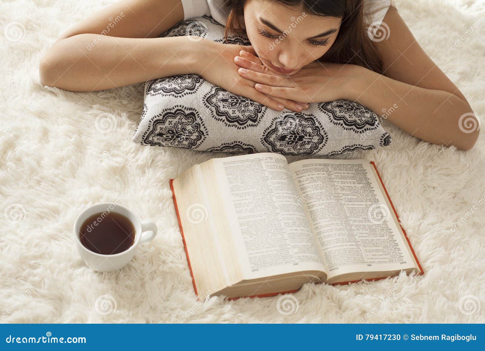 Young Woman Reading Book on Carpet Stock Photo - Image of novel, carpet ...