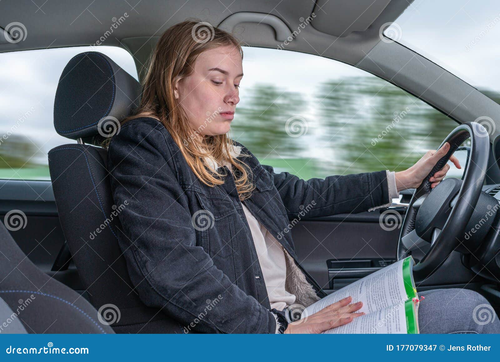 Young Woman is Reading a Book while Driving a Car Stock Image - Image ...