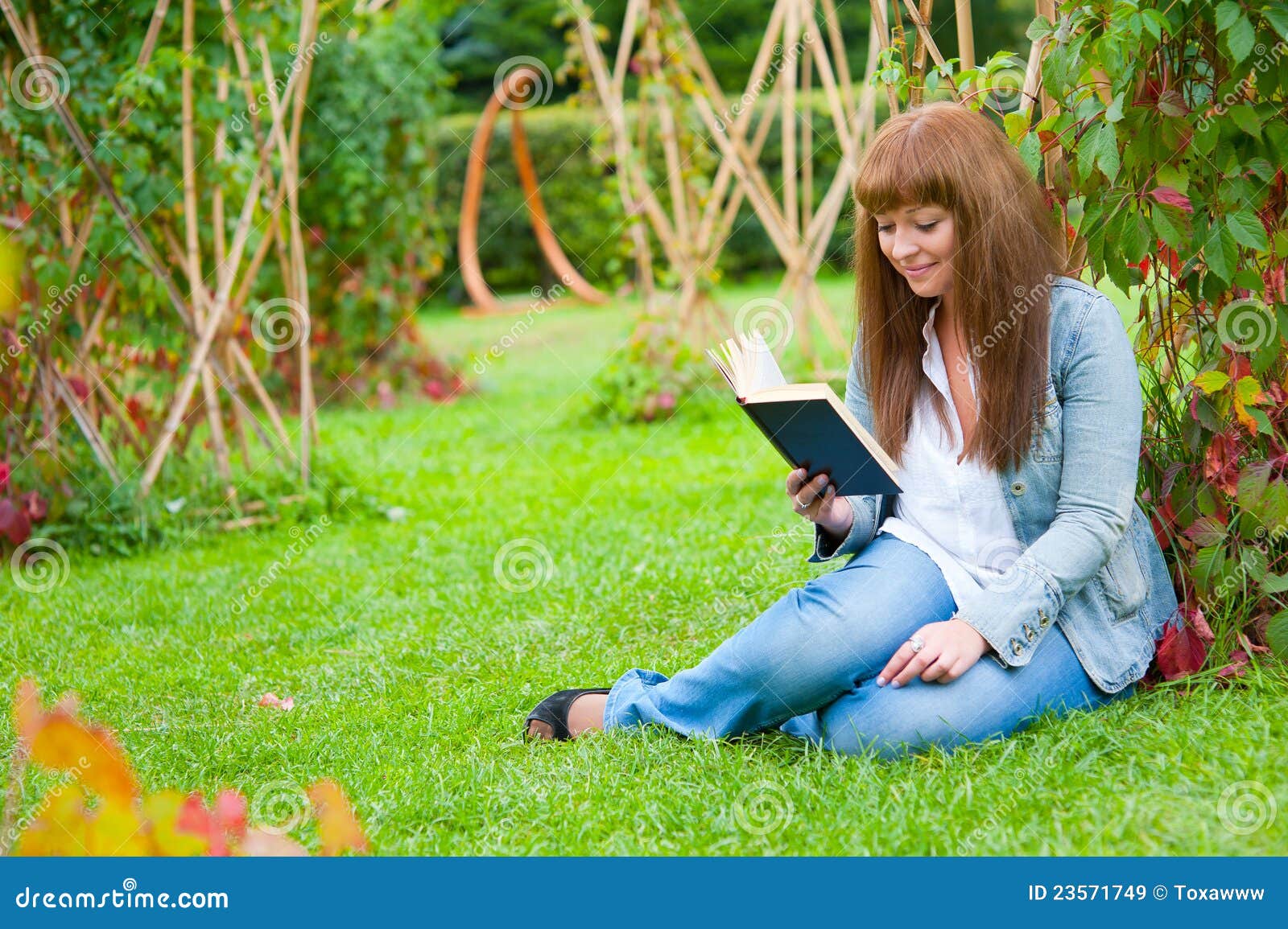 Young Woman Reading a Book Lying on the Grass Stock Image - Image of ...