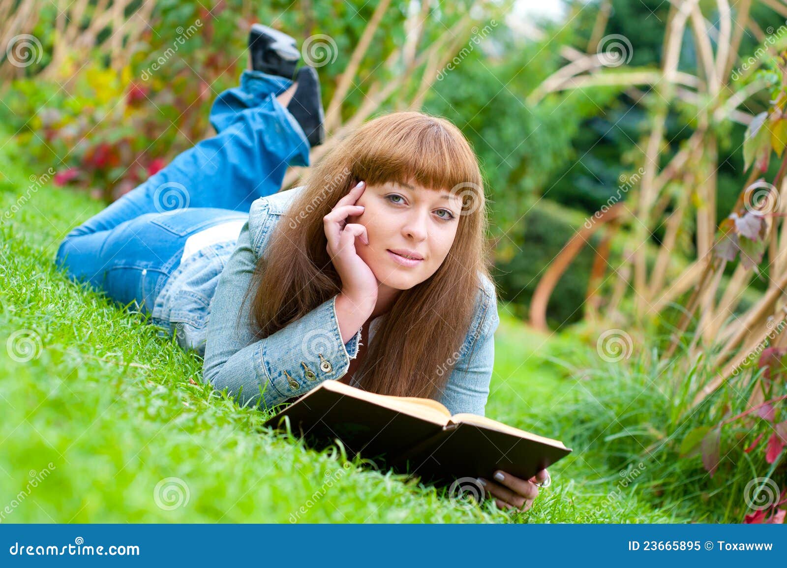 Young Woman Reading a Book Lying on the Grass Stock Image - Image of ...