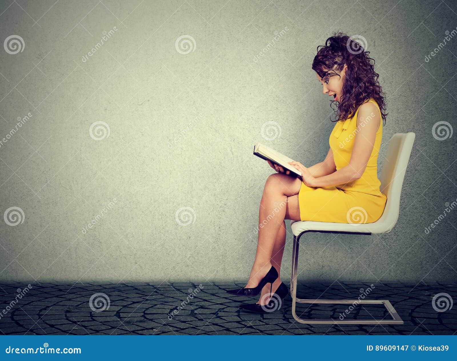 Young Woman Reading A Book Sitting On A Chair Stock Image Image Of