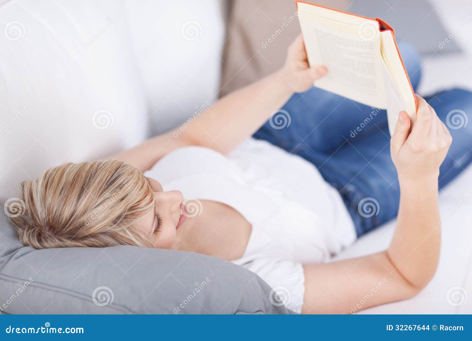 Young Woman Reading a Book on the Sofa Stock Photo - Image of amusement ...