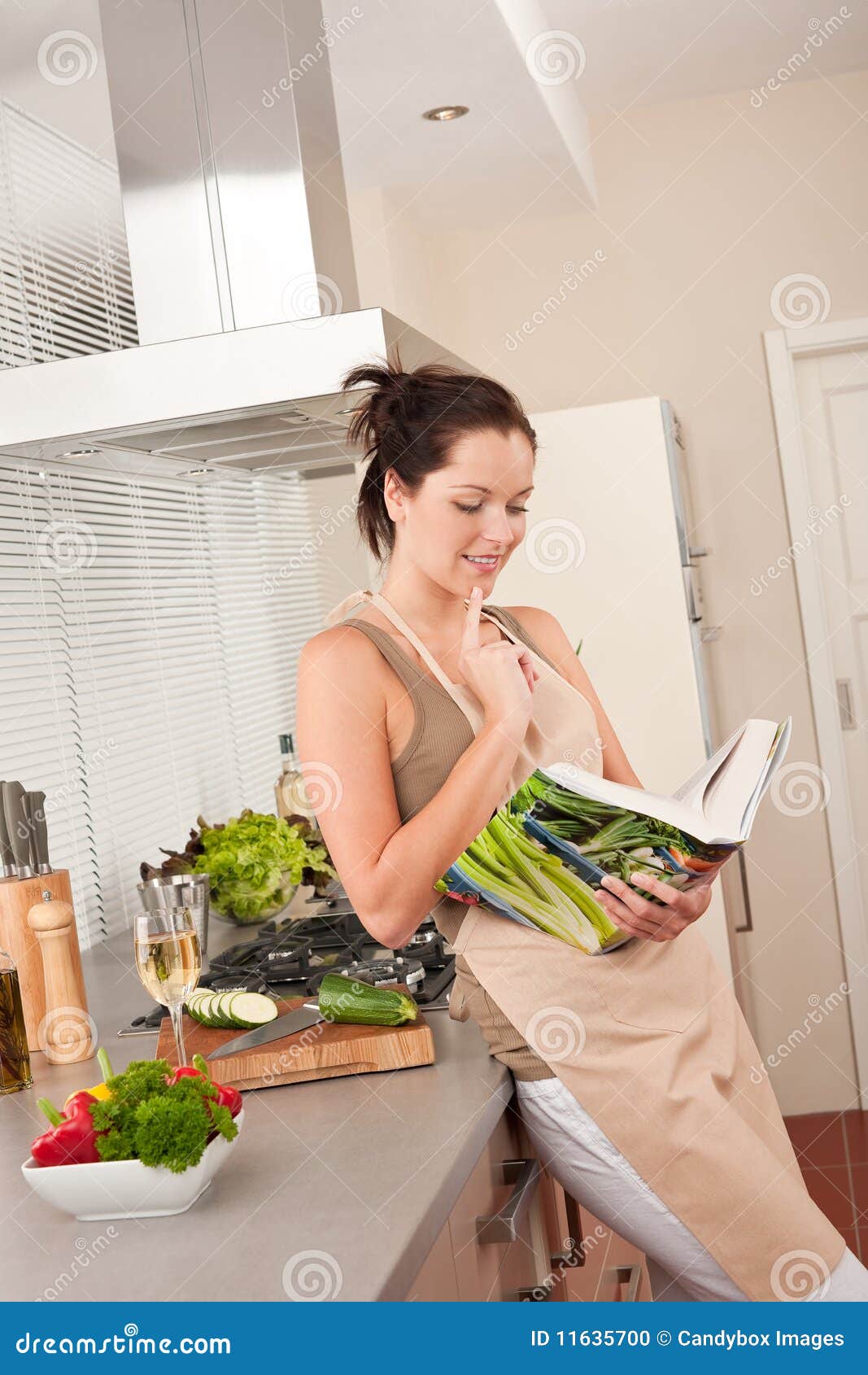 Young Woman Reading Cookbook in the Kitchen Stock Photo - Image of ...