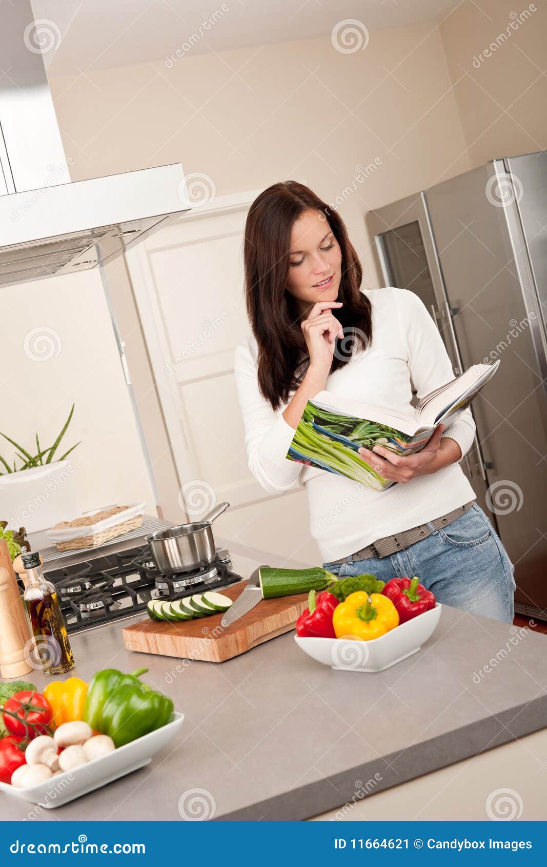Young Woman Reading Cookbook in the Kitchen Stock Image - Image of ...