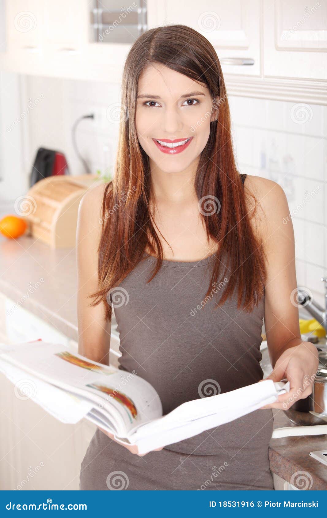 Young Woman Reading Cookbook in the Kitchen Stock Photo - Image of ...