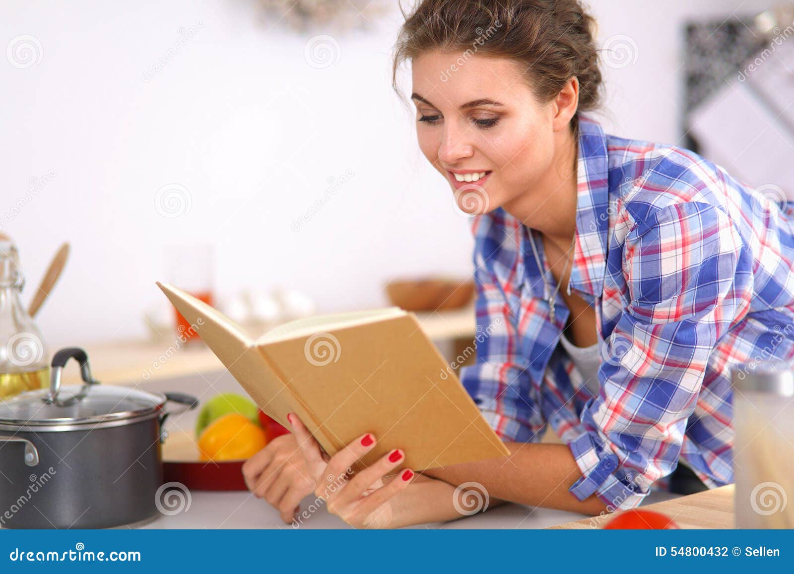 Young Woman Reading Cookbook in the Kitchen Stock Photo - Image of ...