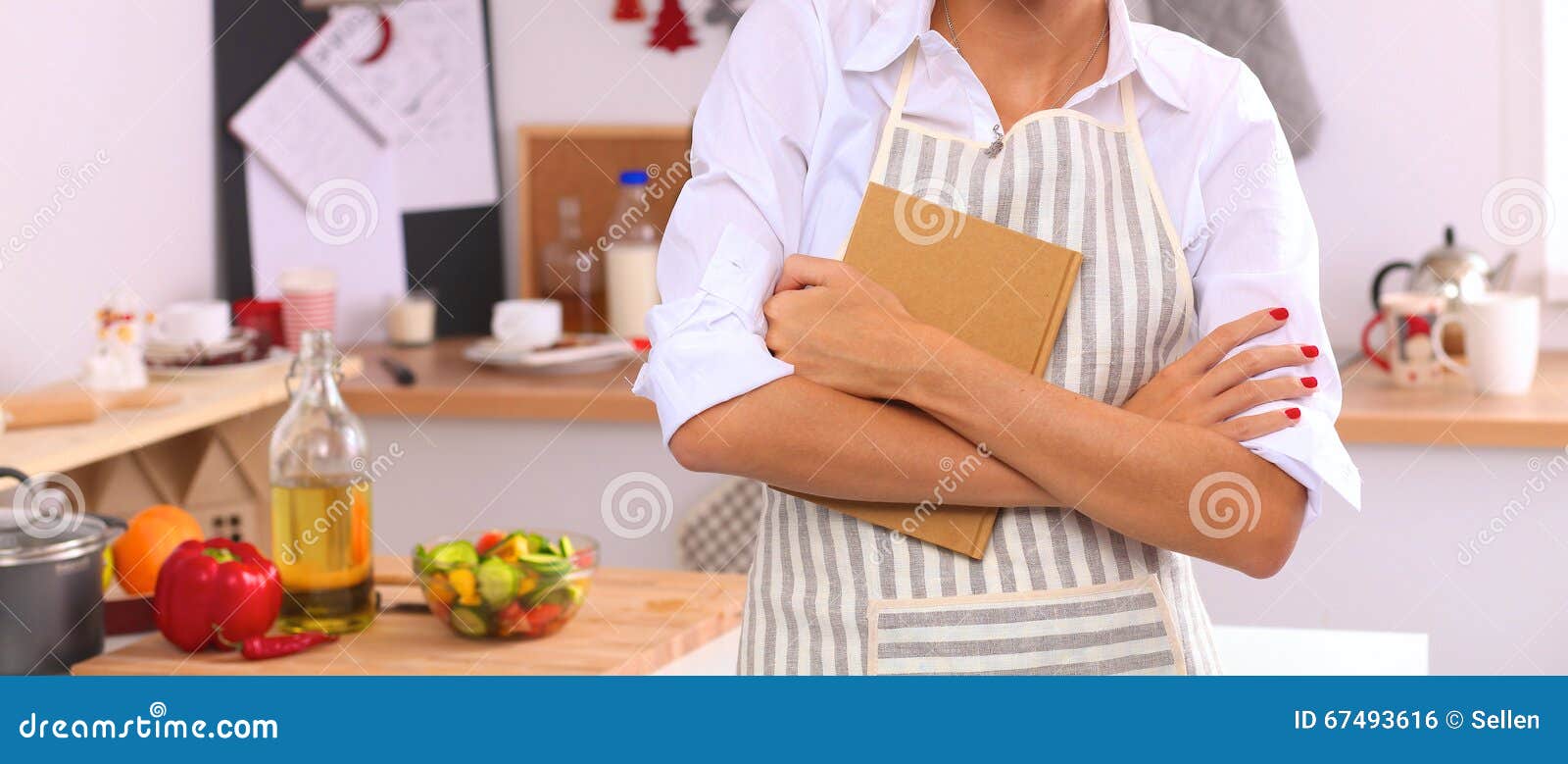 Young Woman Reading Cookbook in the Kitchen, Looking for Recipe Stock ...