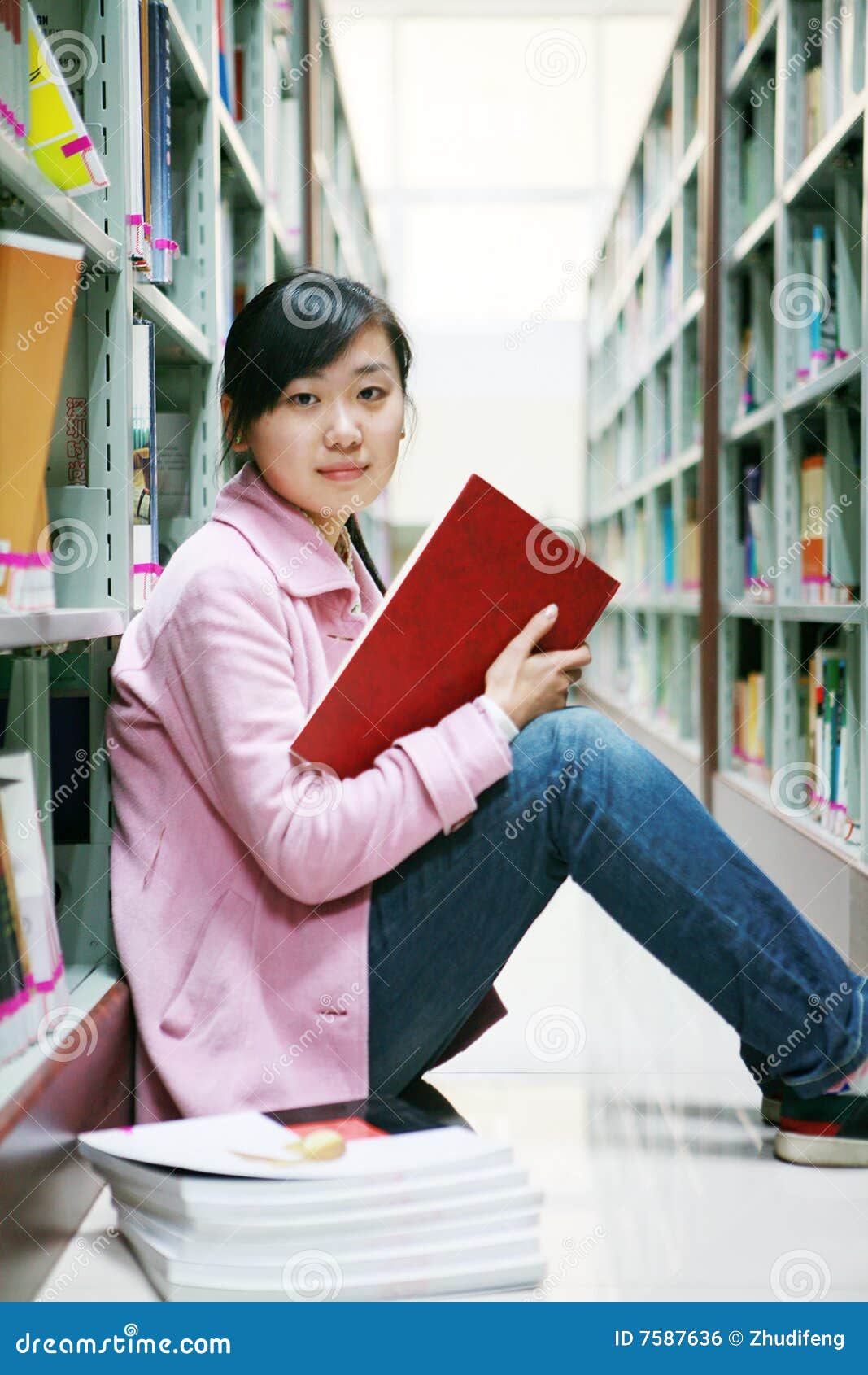 Young Woman Reading in Library Stock Photo - Image of bookshelf ...