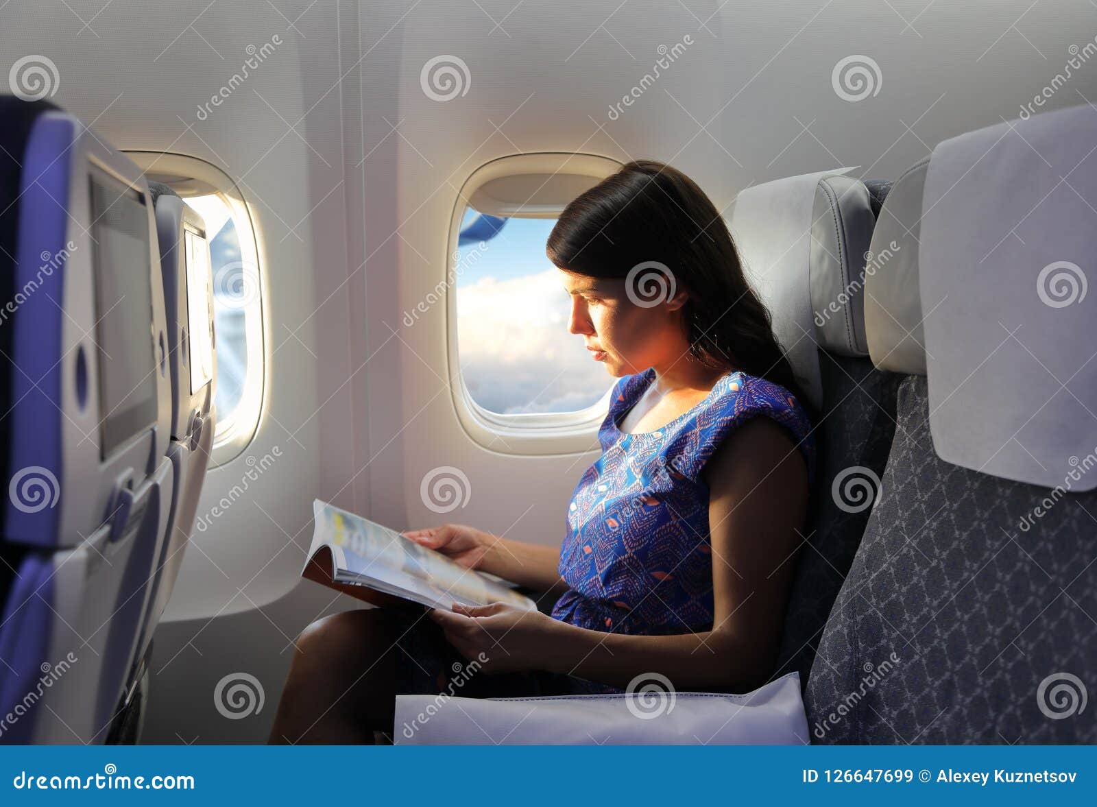 Young Woman Reading Magazine during the Flight Stock Image - Image of ...