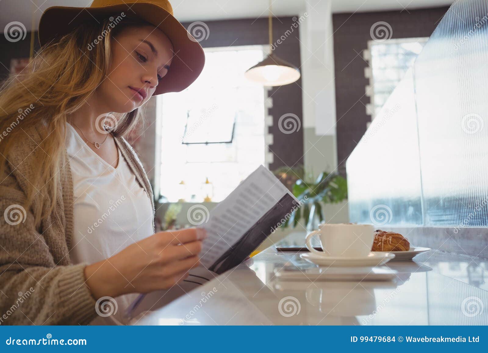 Woman reading menu in cafe stock photo. Image of food - 99479684