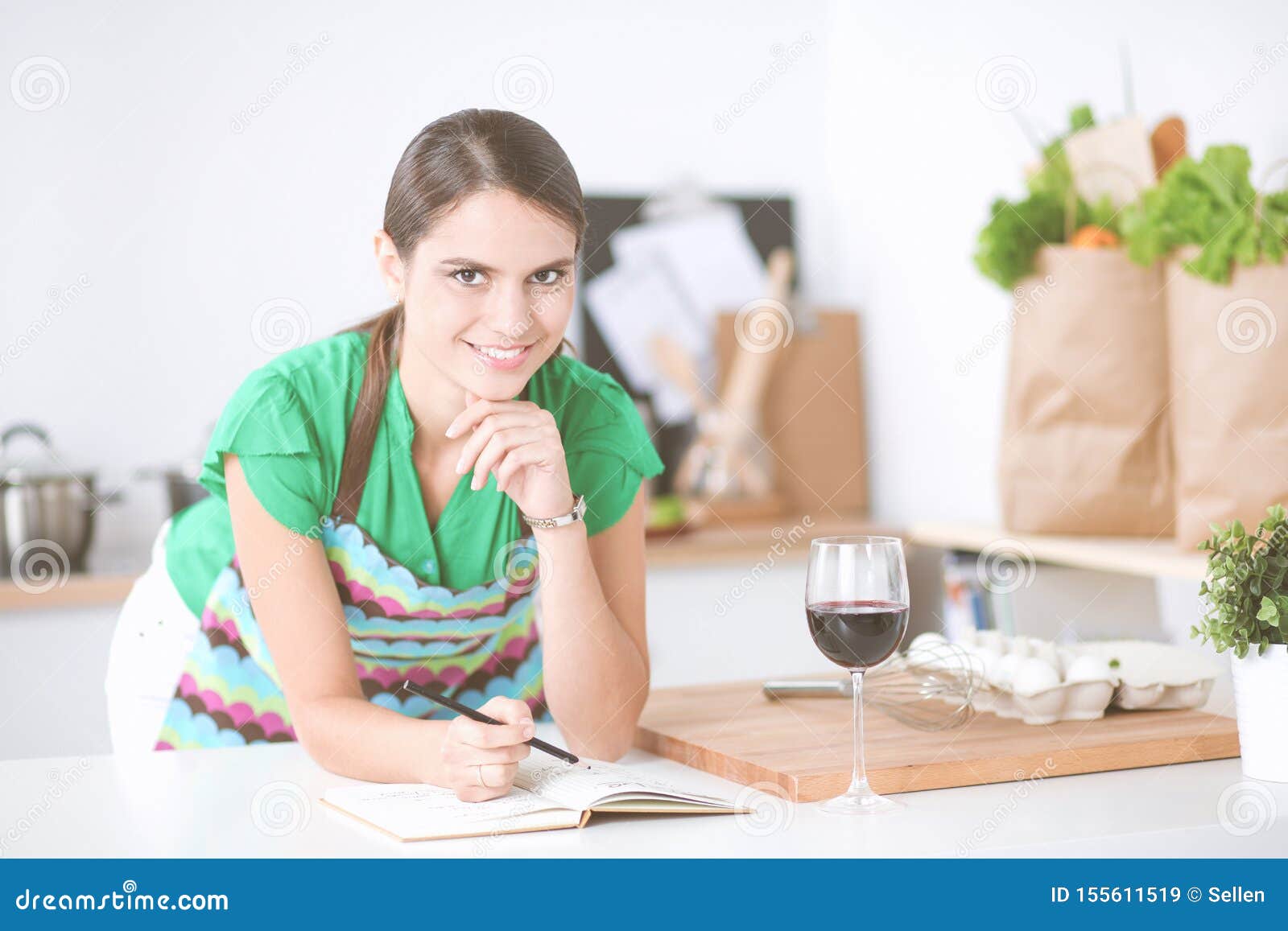 Young Woman Reading a Recipe Book in the Kitchen Stock Image - Image of ...