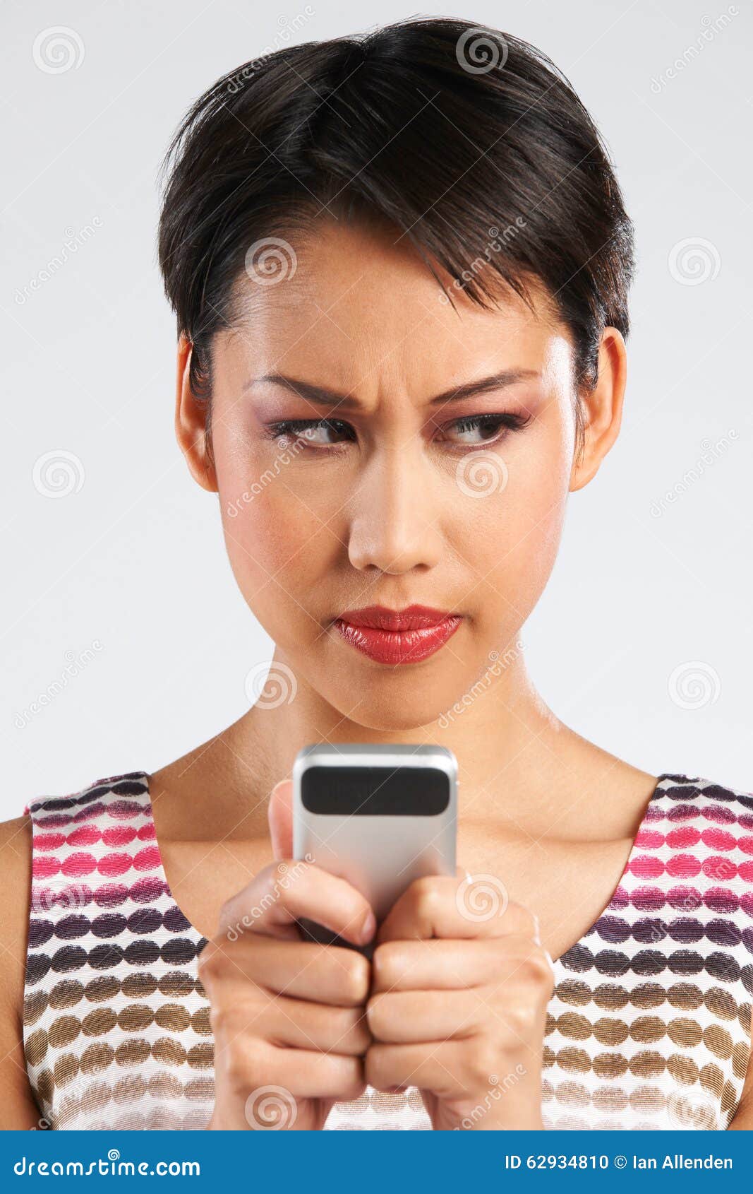 Young Woman Reading Text Message with Annoyed Expression Stock Photo ...