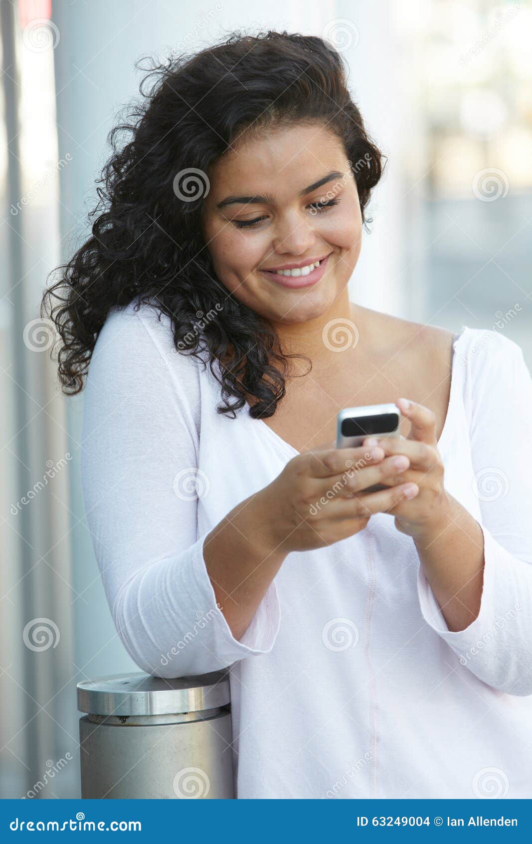 Young Woman Reading Text Message in Urban Setting Stock Photo - Image ...