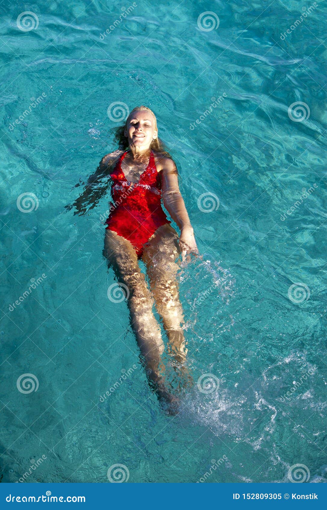 Young Woman In A Red Bathing Suit Swimming In The Blue Sea In Tahiti Stock Image Image Of