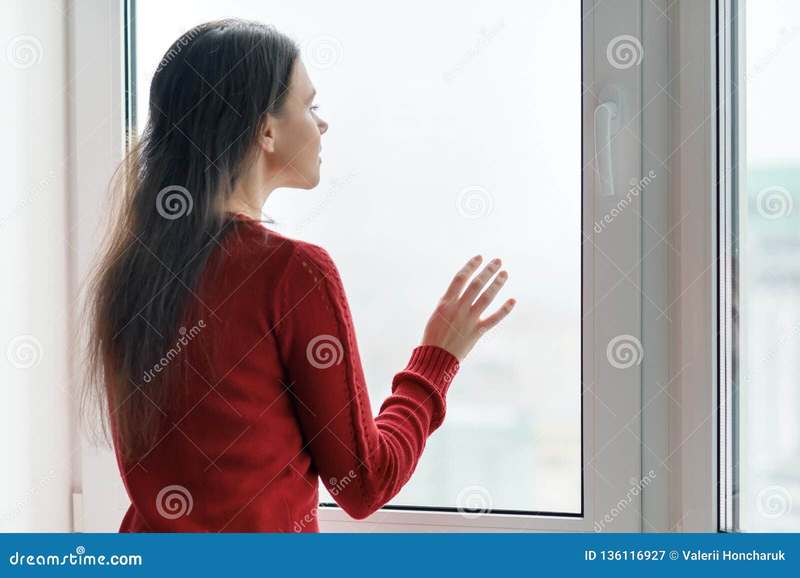 Young Woman In Red Sweater Looking Out The Window Female Put Her Hands