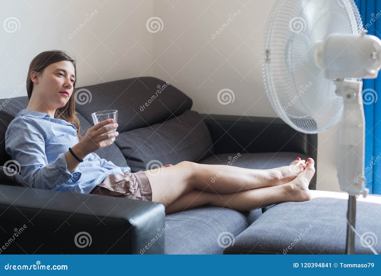 Young Woman Refreshing in Front of Cooling Fan Stock Image - Image of ...