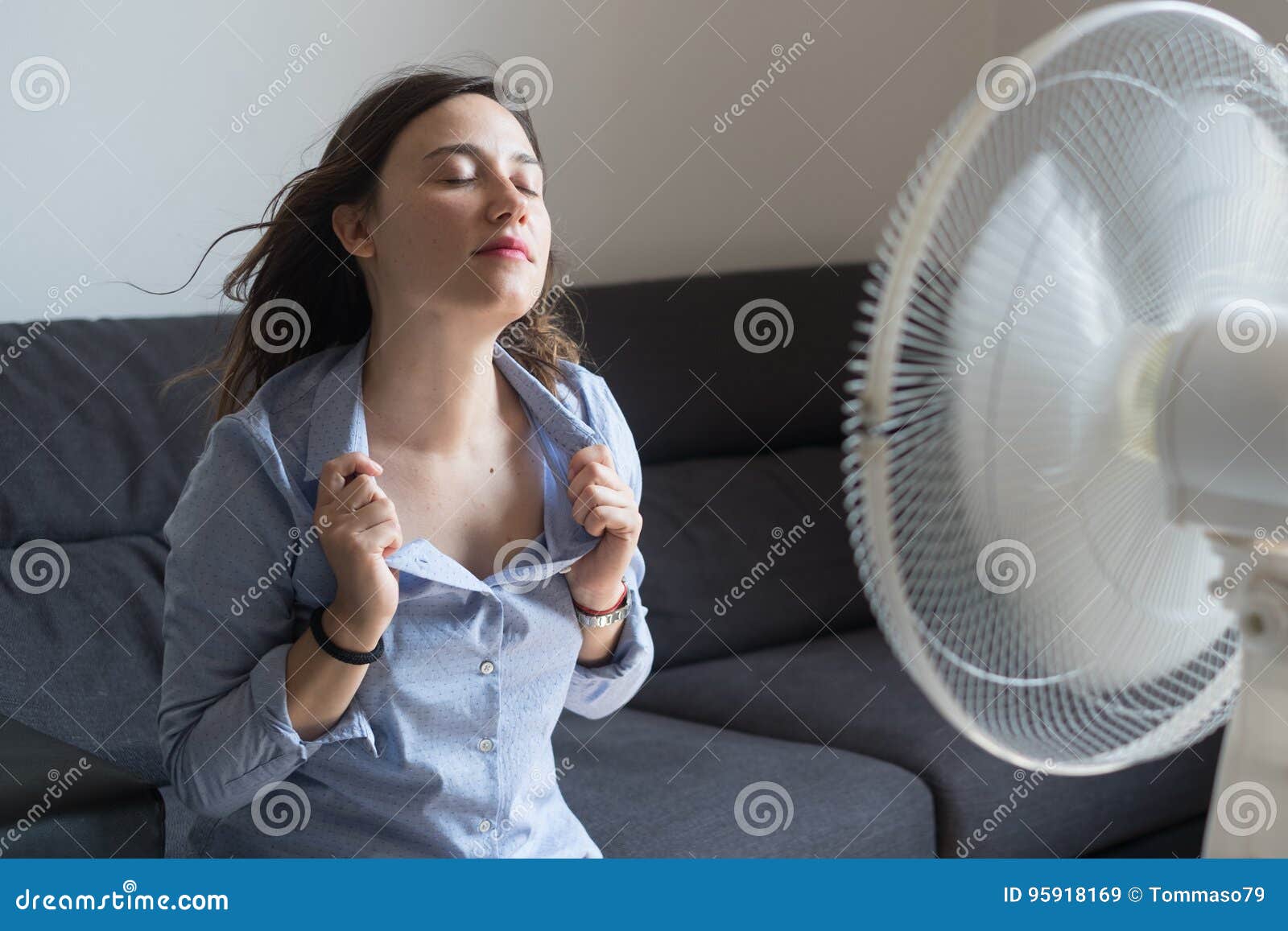 Young Woman Refreshing in Front of Cooling Fan Stock Image - Image of ...