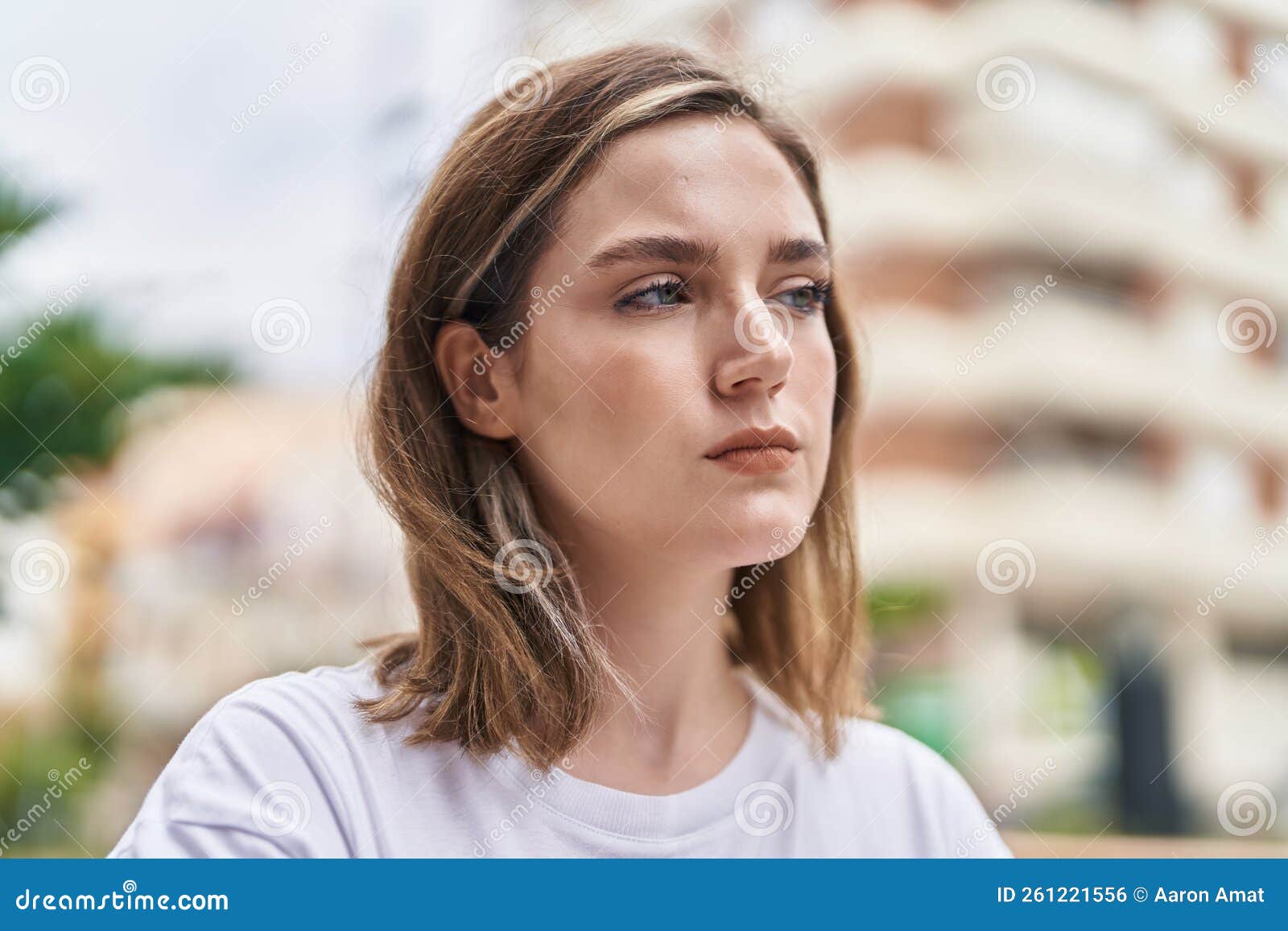 Young Woman with Relaxed Expression Standing at Street Stock Photo ... Young Woman with Relaxed Expression Standing at Street Stock Photo ...
