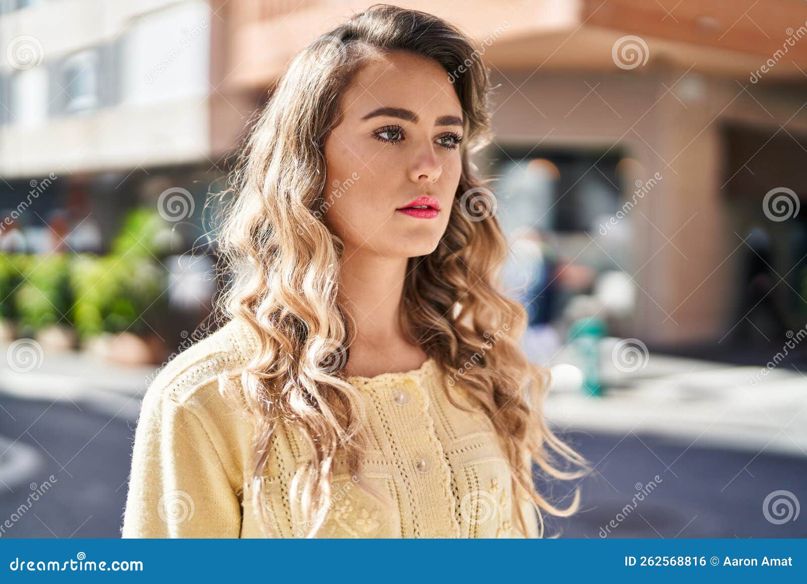 Young Woman with Relaxed Expression Standing at Street Stock Photo ...