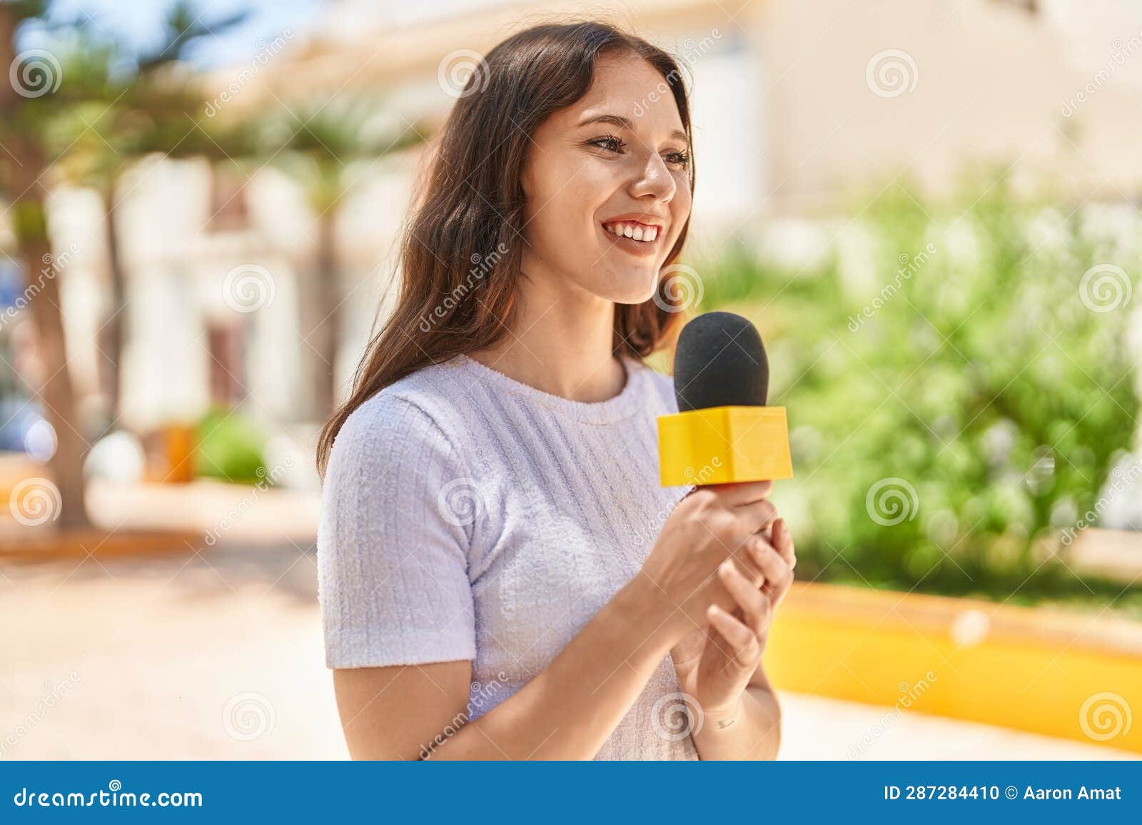 Young Woman Reporter Working Using Microphone at Park Stock Photo ...