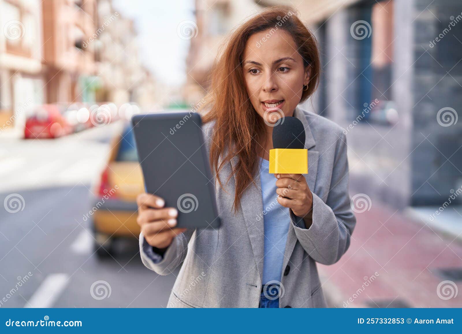 Young Woman Reporter Working Using Microphone and Touchpad at Street ...