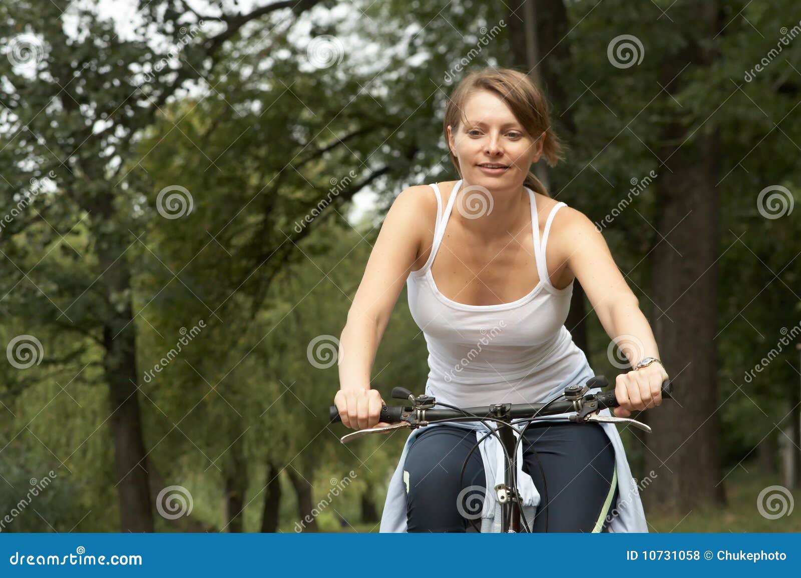 Young Woman Riding with Bike Stock Photo - Image of green, biker: 10731058